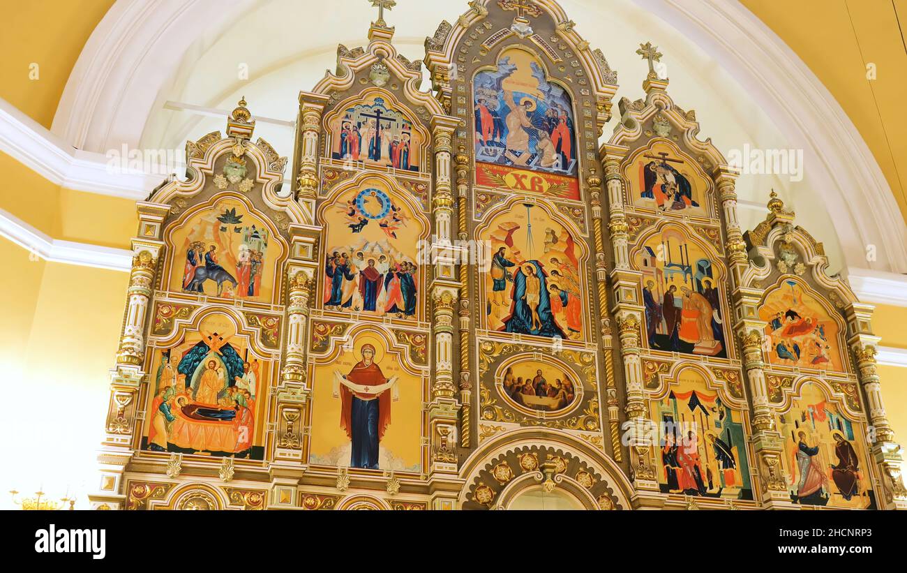 View inside of the Orthodox church with gold iconostasis showing biblical stories, religion ...