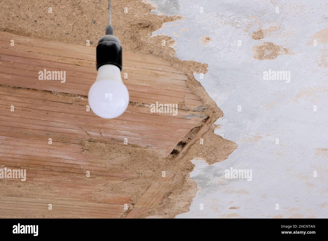Interior reconstruction on Ruined old ceiling and hanging lamp. Repair ...