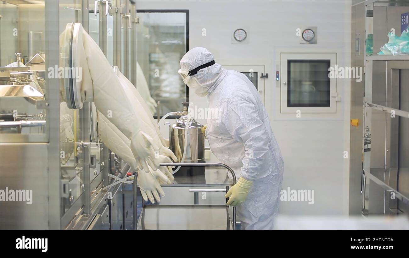 Worker At Pharmaceutical Factory. Lab technician working inside a ...