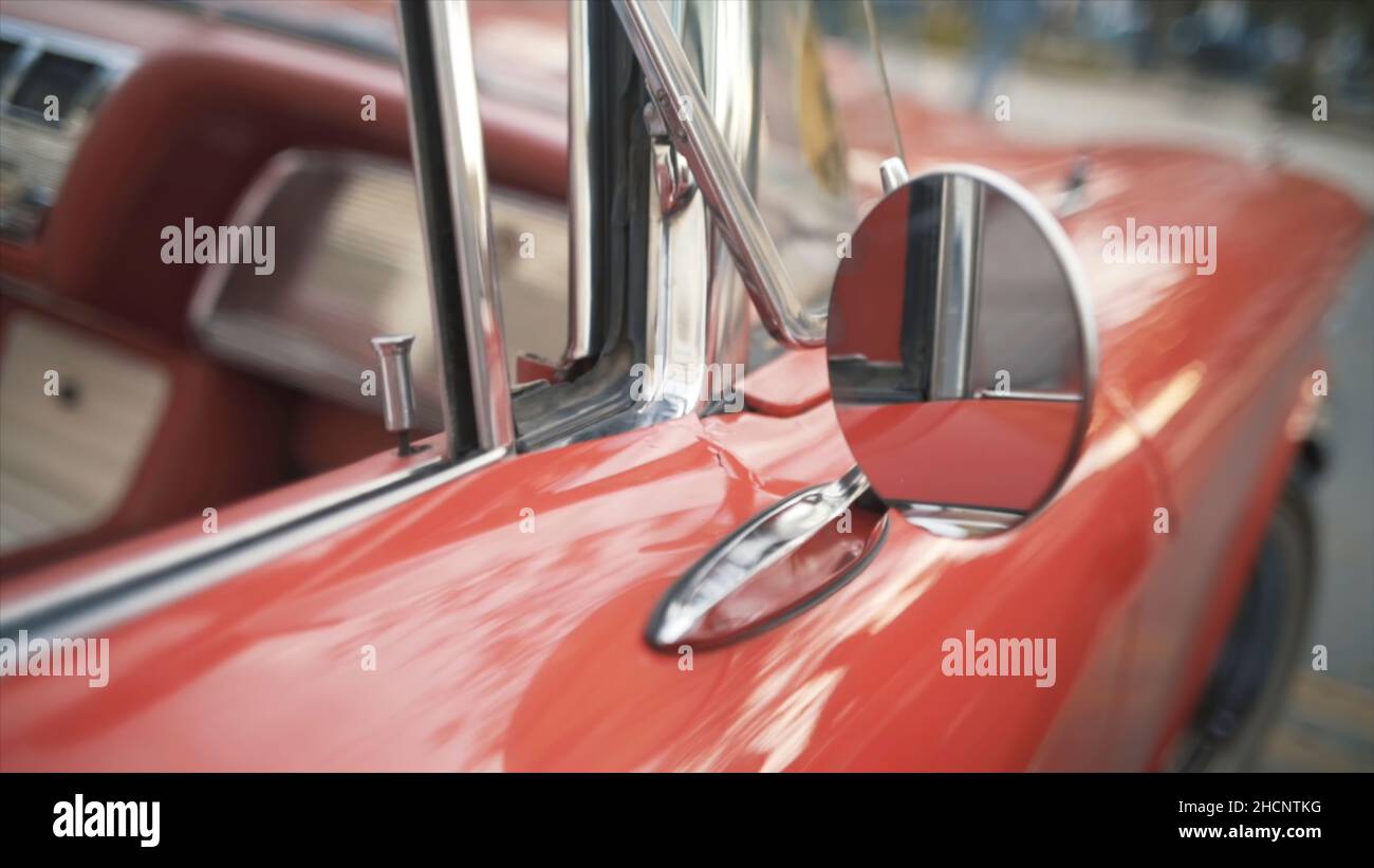 Details of red retro car on a blurred city background. Close up of ...