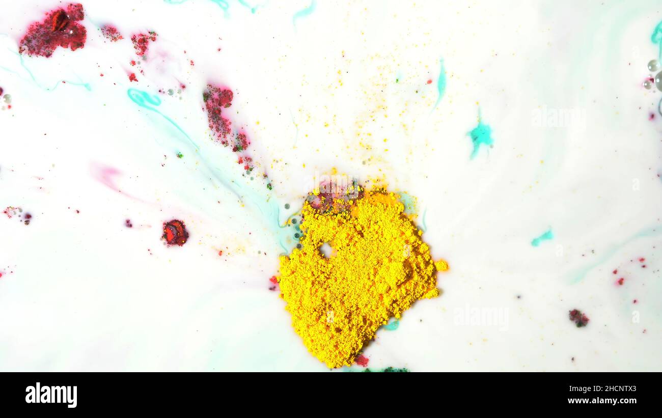 Colorful powder ink flowing on milk, top view. Close up for dry ...