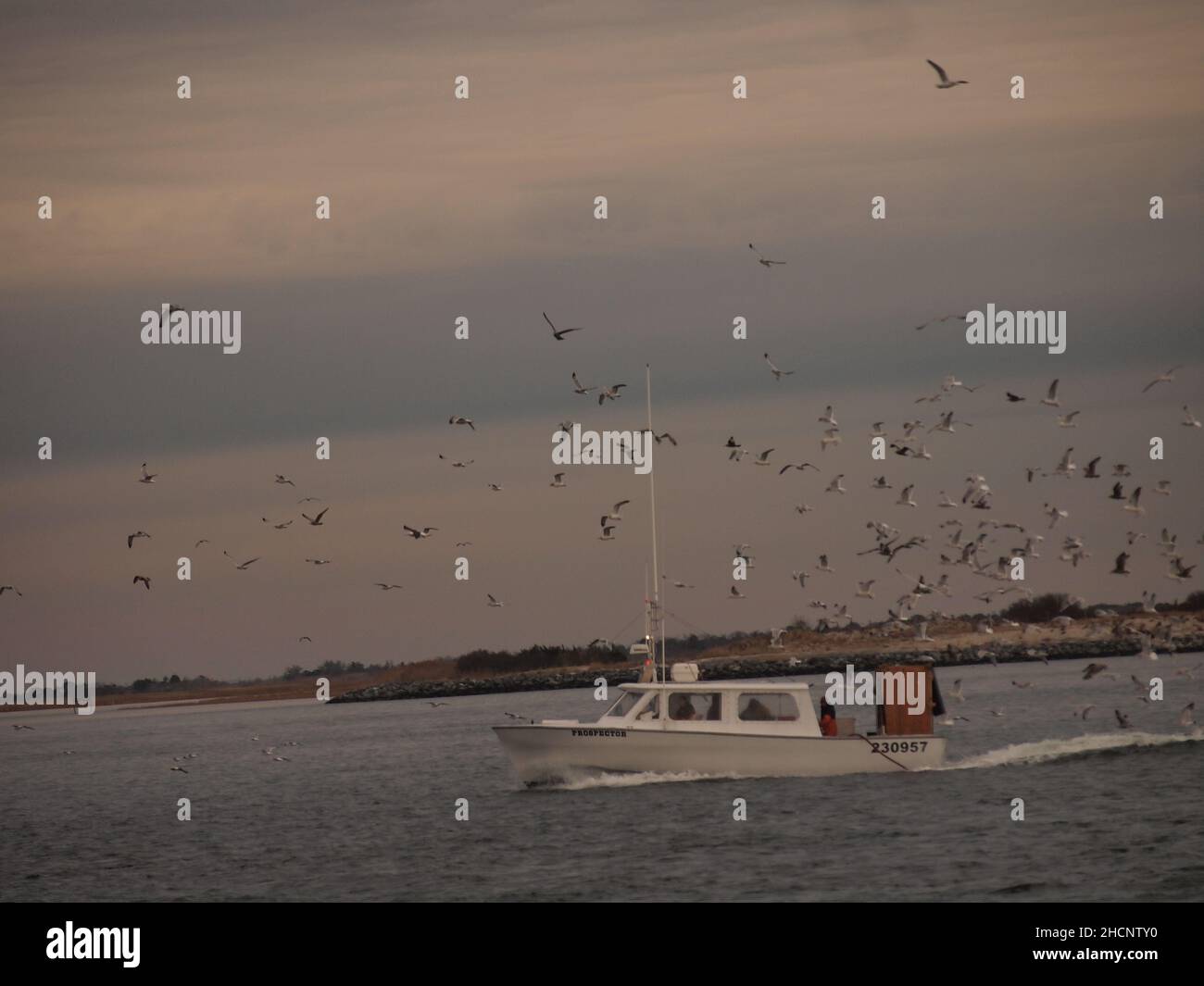 Fishing boat entering Barnegat Bay near the Island Beach State Park ...
