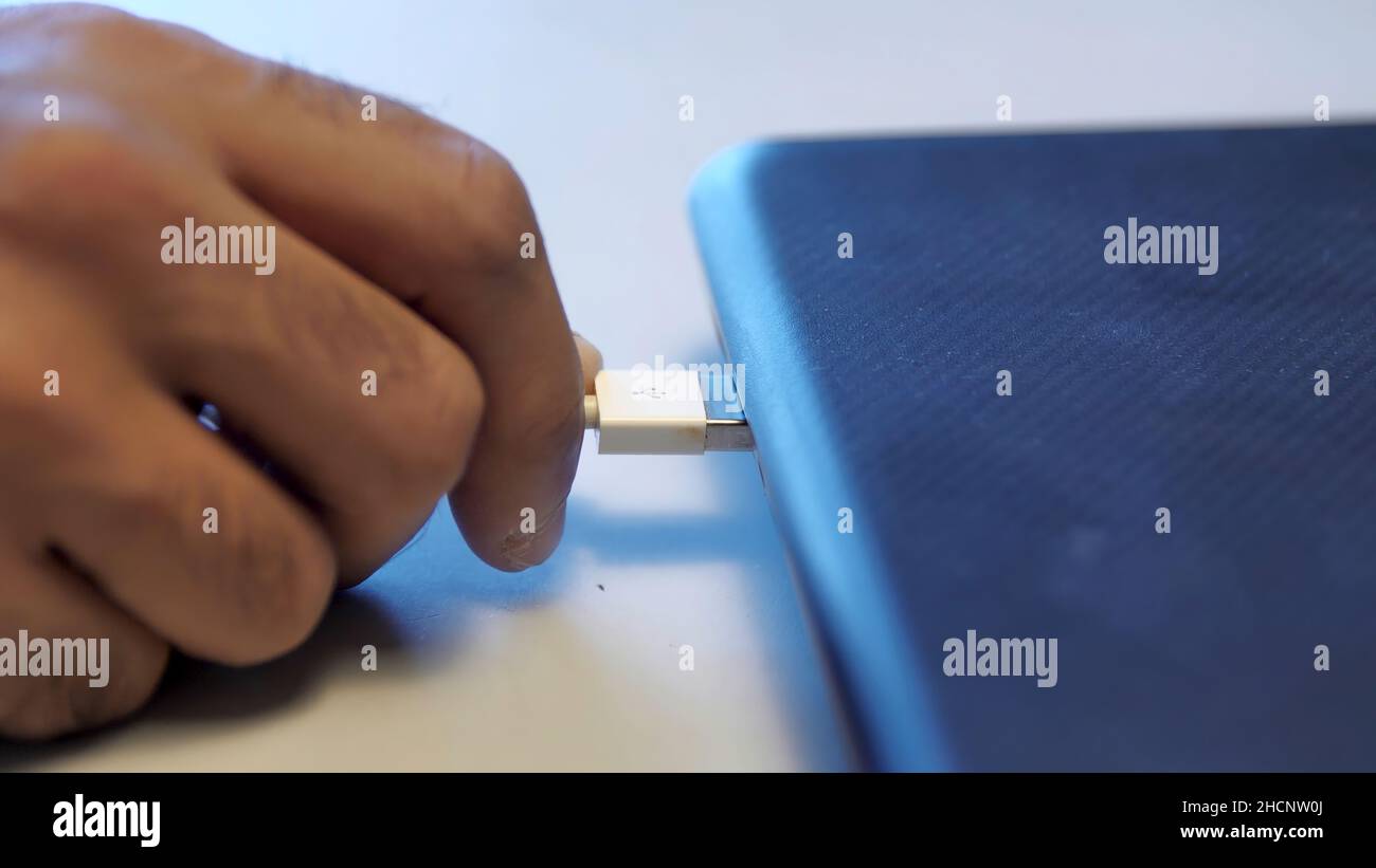 Man inserting usb cable into laptop. Close up of male hand Stock Photo ...