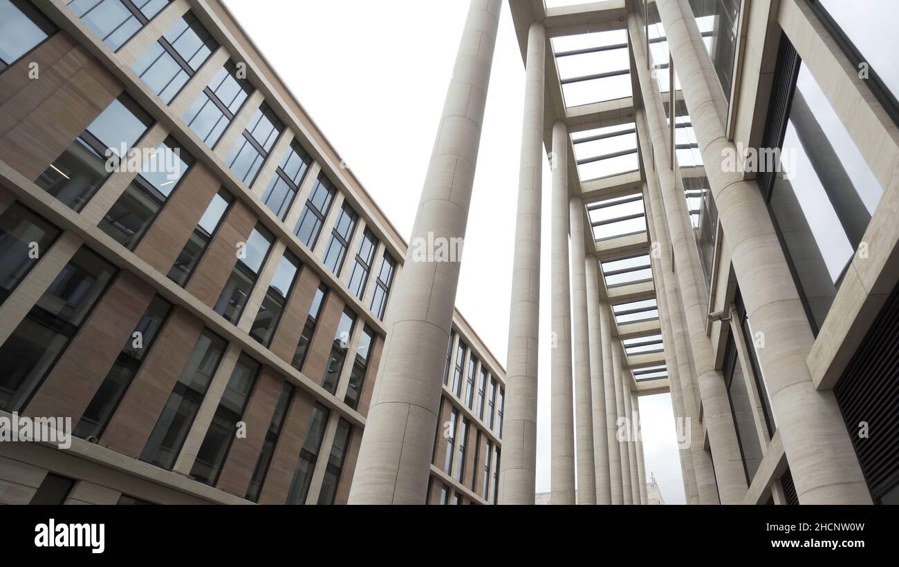Facade of a building with marble columns. Bottom view of a modern ...