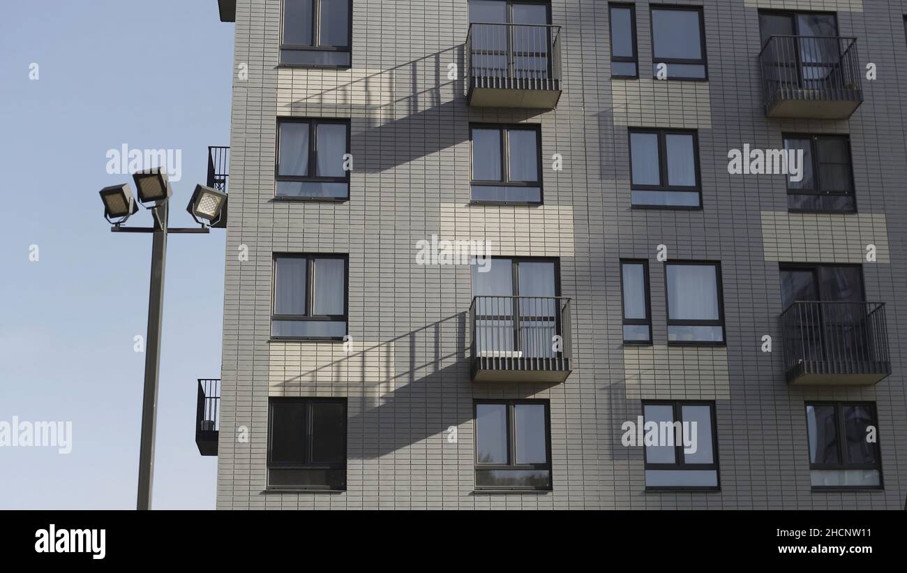Bottom view of residential new building made of white bricks. Fragment ...