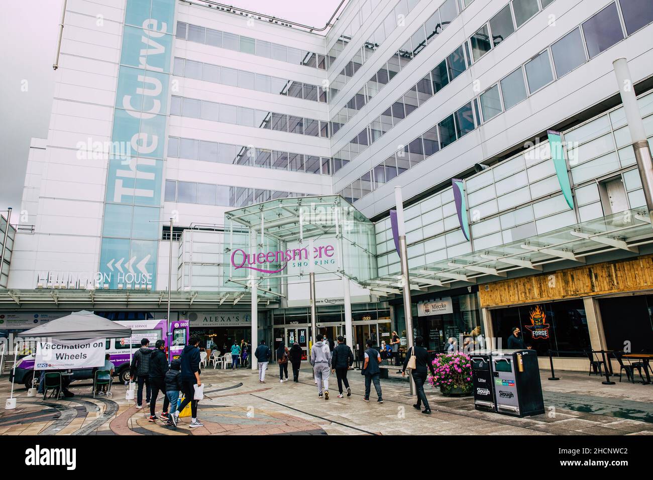 Slough, UK. 10th July, 2021. Shoppers approach an entrance to the ...