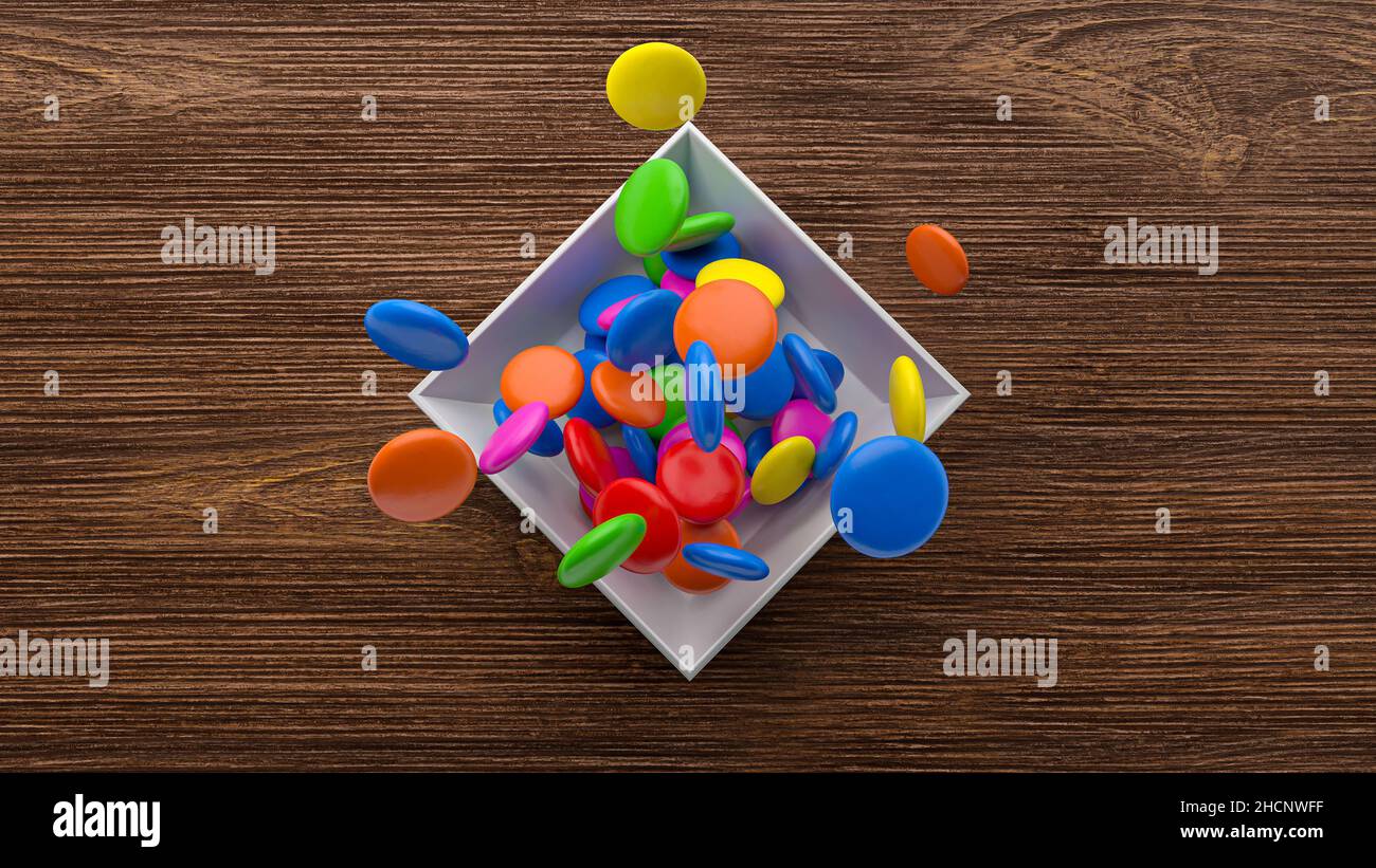 Colorful candies in rainbow colors Falling on white porcelain bowl and ...