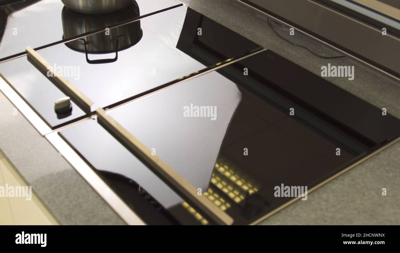 Close up of functional kitchen induction hob in a new flat. Details of ...