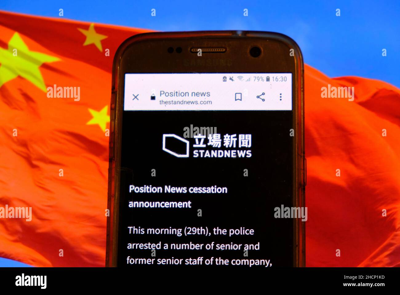 The defunct Stand News webpage displayed on a smartphone with a photo ...