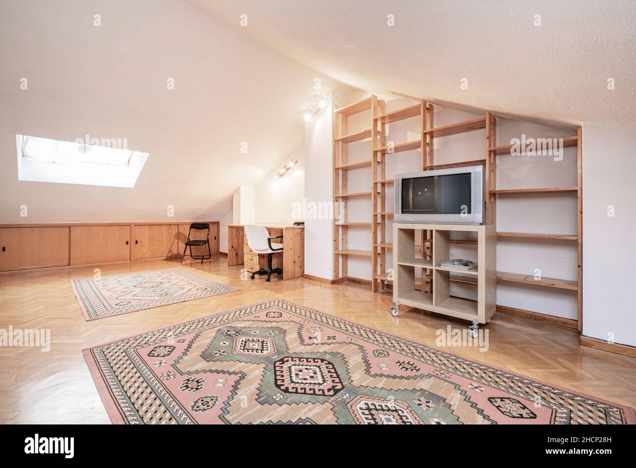 Upstairs loft of a single-family residential home with wooden shelving ...