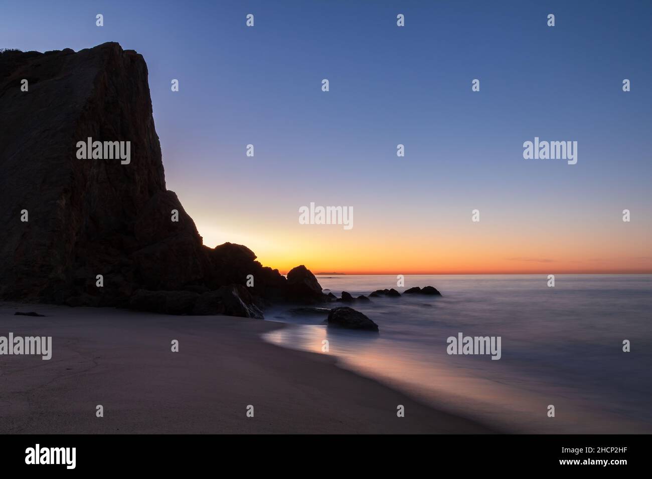 Beach in Malibu, California at dawn. Cliffs of Point Dume in background ...