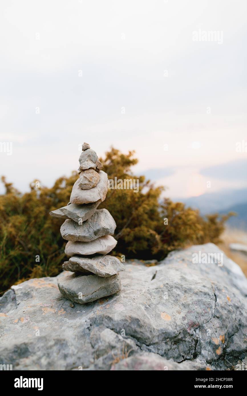 Pyramid of stones on a large stone at the top of a mountain Stock Photo ...
