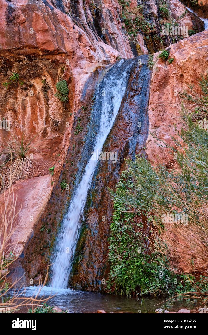 A waterfall flows over red rock in Stone Creek, at Mile 132 in the ...