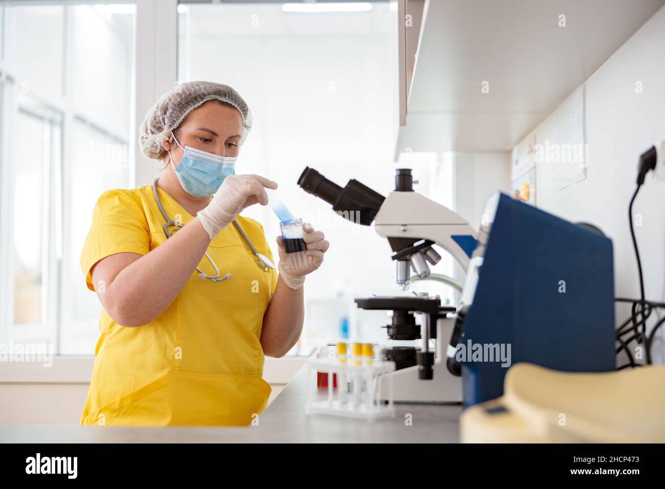 Science veterinarian working with microscope in lab Stock Photo - Alamy