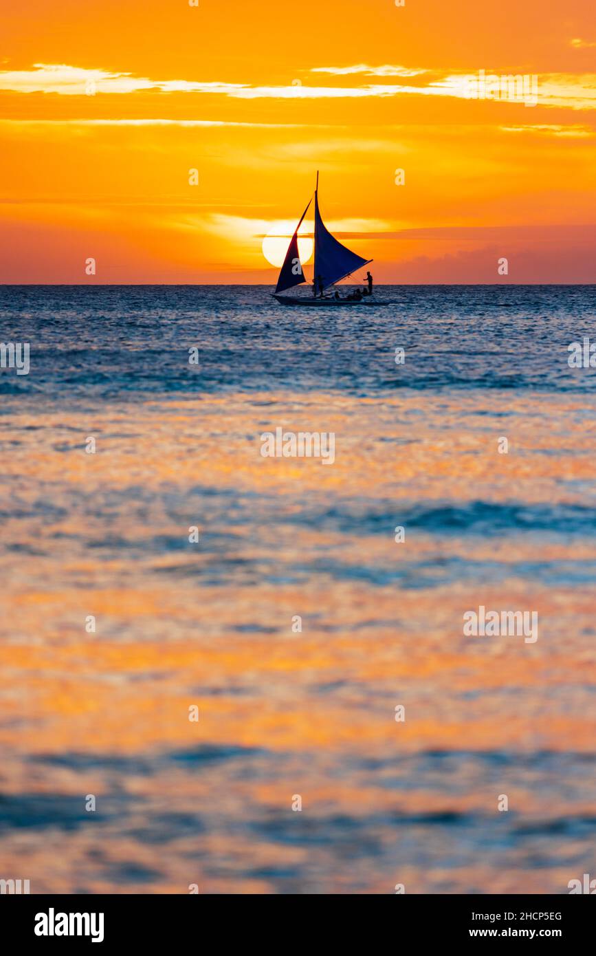 Golden skyline during sunset with sailboats in Boracay, Aklan ...