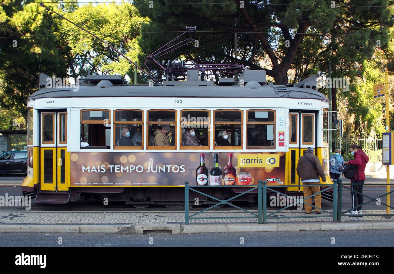 Iconic yellow Lisbon tram car, No 28, at the Estrela stop, Lisbon ...