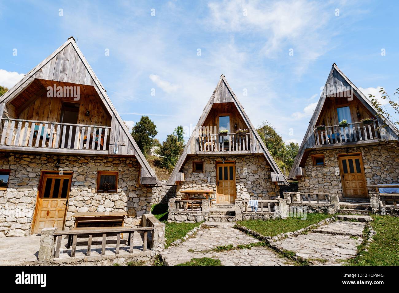Stone paths lead to two-storey triangular houses. Montenegro Stock ...