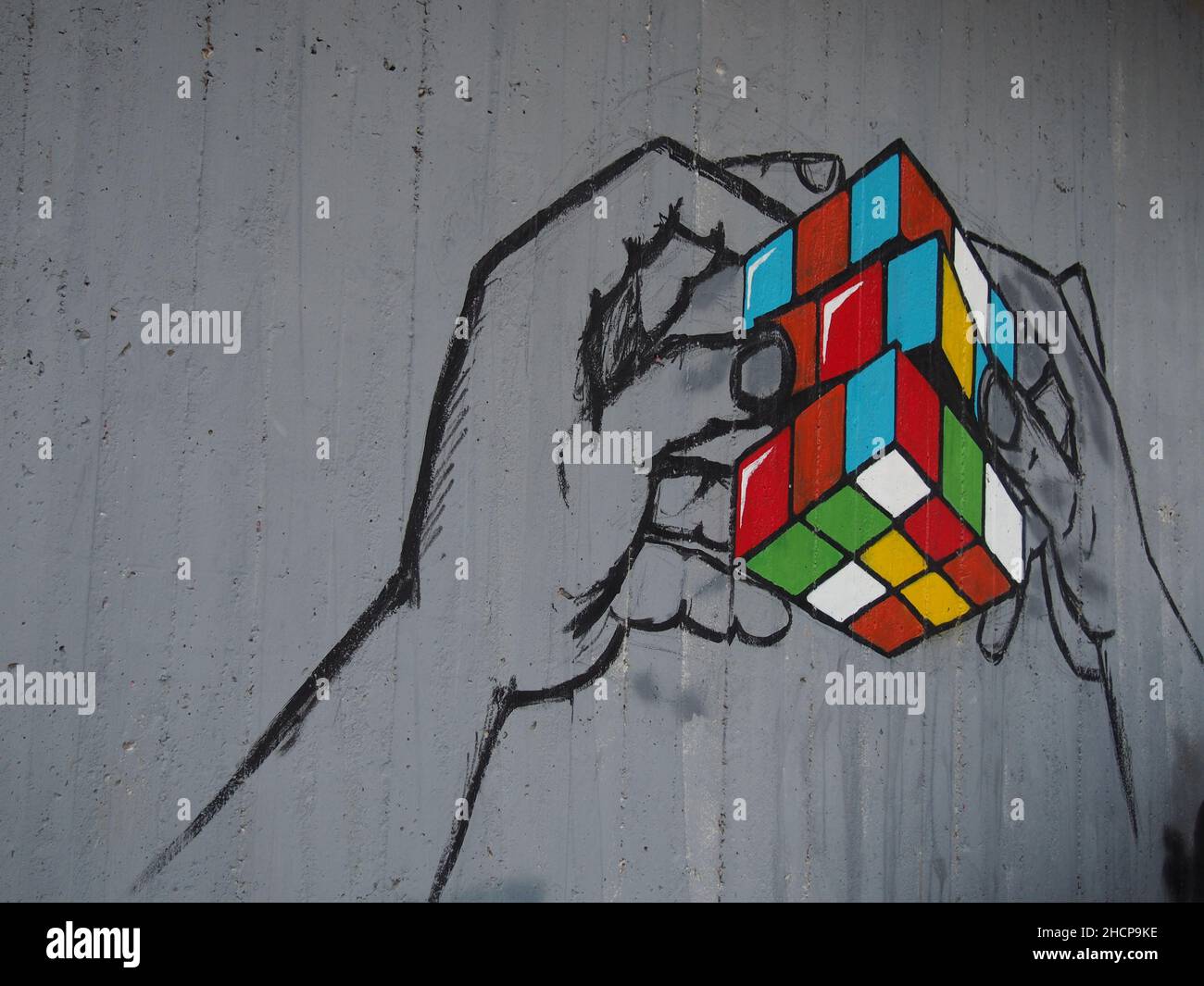 Rubik's cube in the hands of a man. Graffiti Stock Photo - Alamy