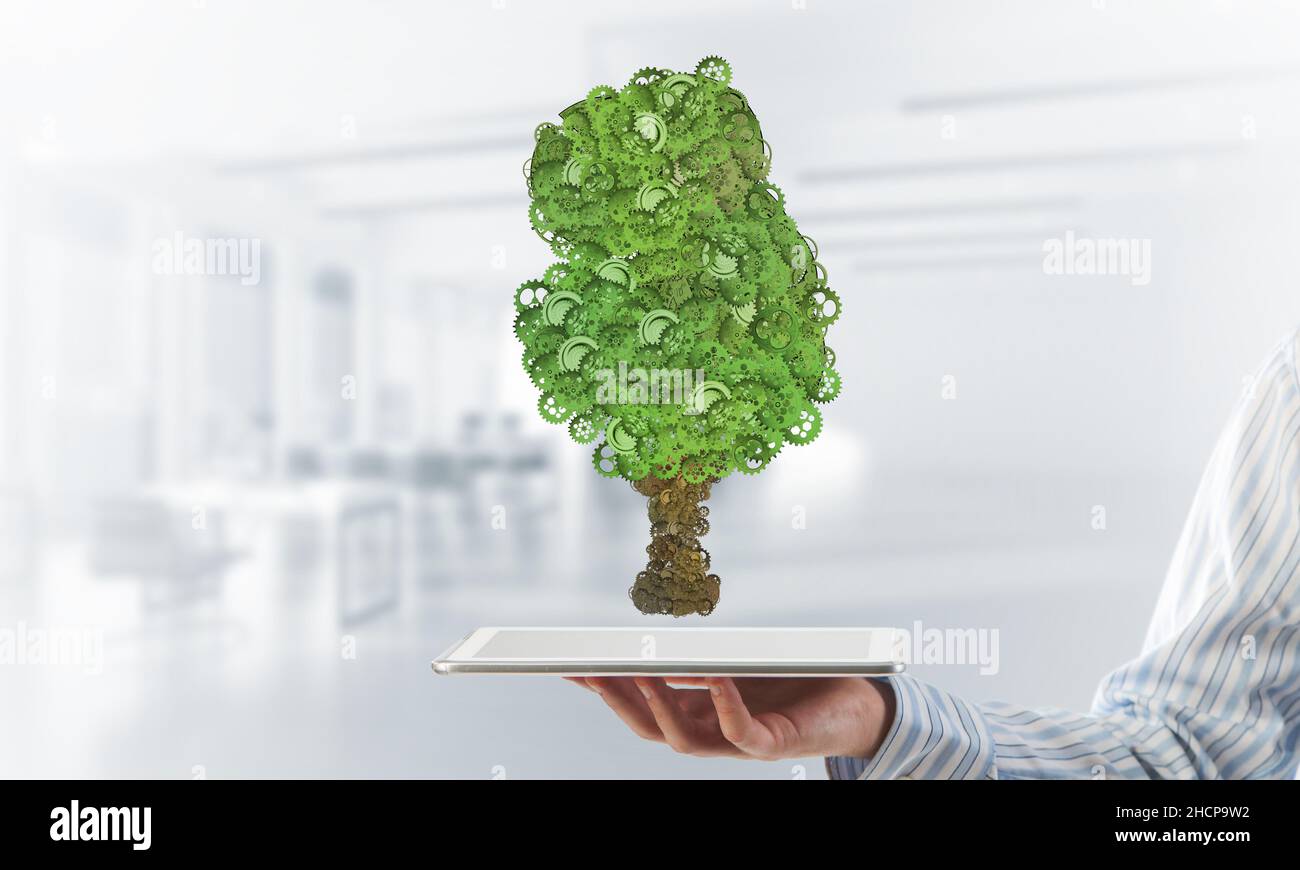 Eco green environment concept presented by tree as working mechanism or ...