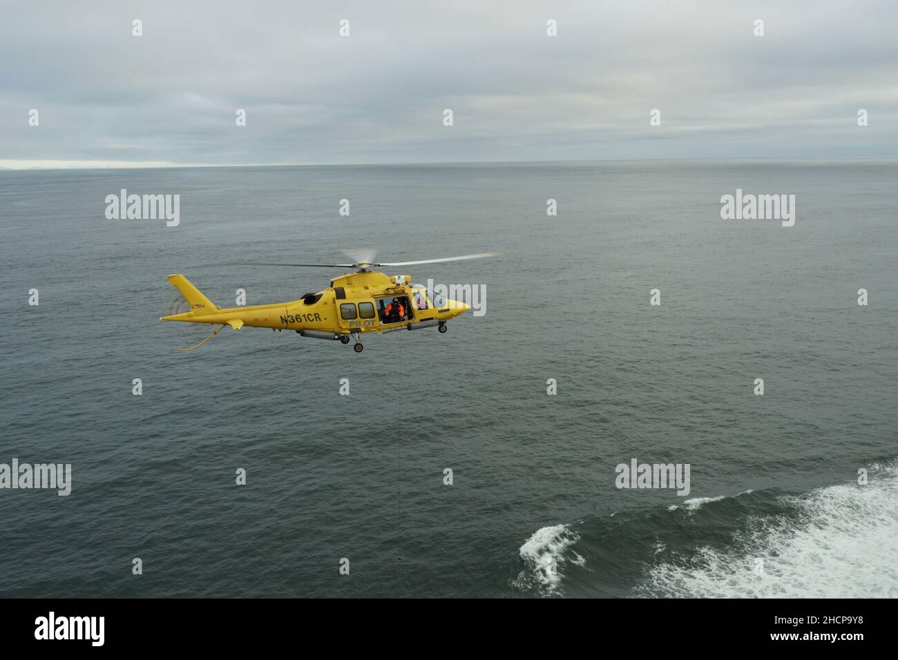 Flying yellow helicopter of Columbia River Bar Pilots ready for ...