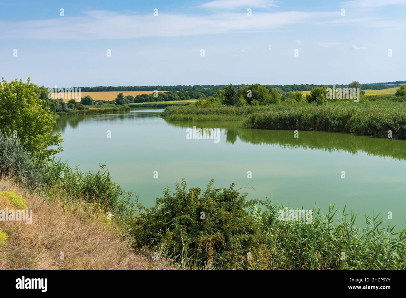 Ukrainian rural landscape with small river Sura at late summer season ...