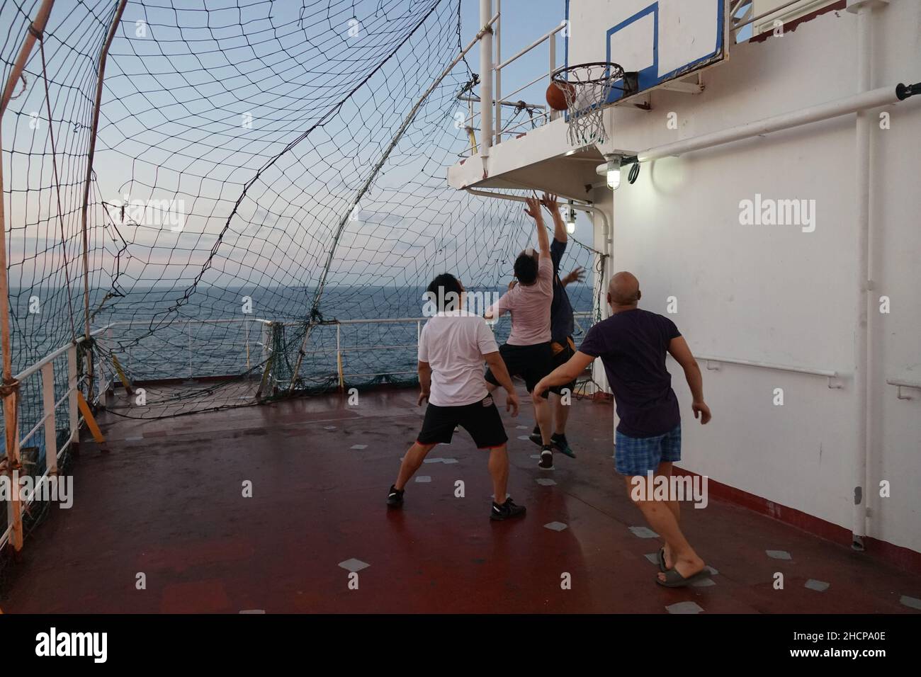Crewmembers playing basketball on container merchant ship Stock Photo ...