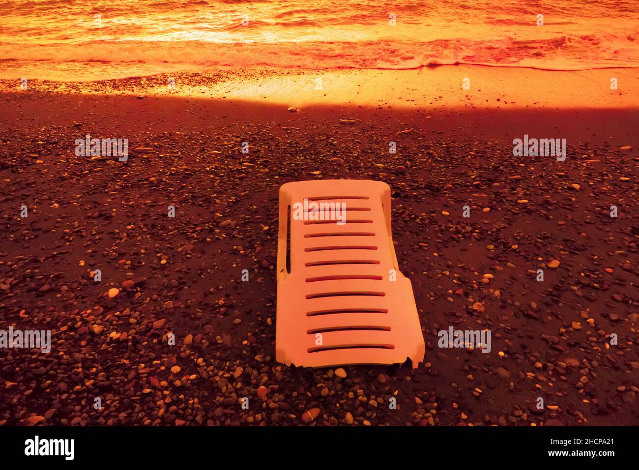 Business collapse. Beach lounger broken by storm on empty beach ...