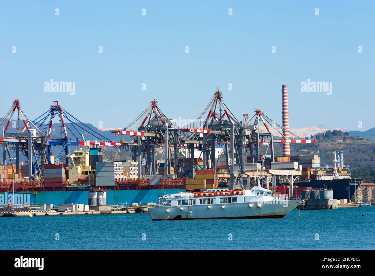 Container ships, containers and cranes in the harbor of La Spezia ...