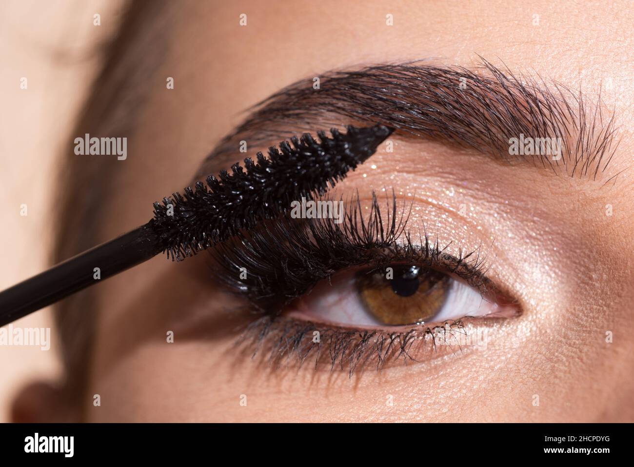 Eyebrow makeup. Macro close up of brows. Woman brushing brows with ...