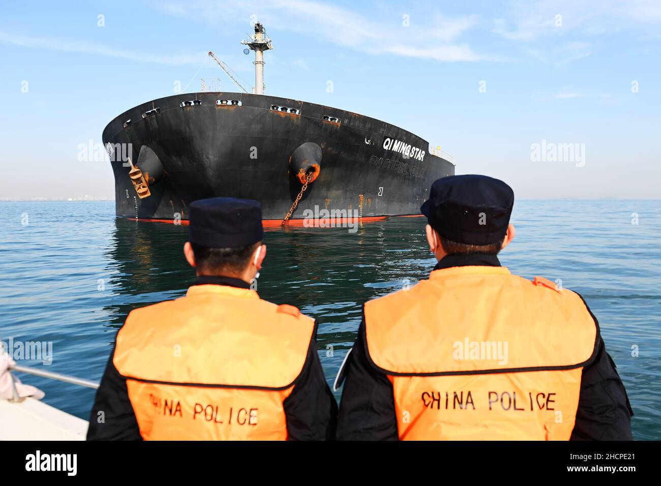 QINGDAO, CHINA - DECEMBER 31, 2021 - Policemen on duty at the entry and ...