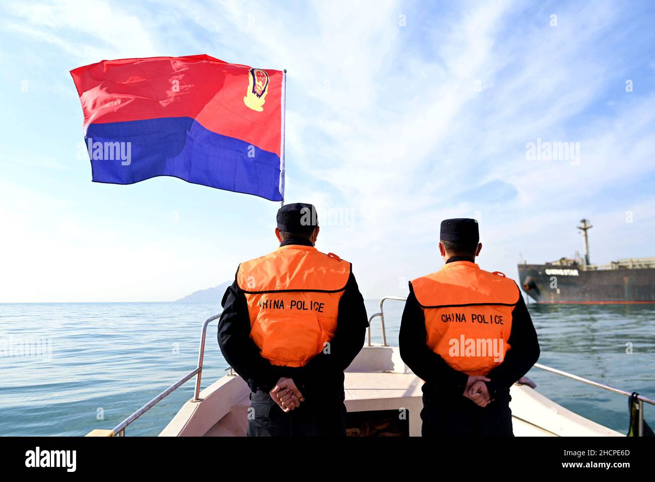 QINGDAO, CHINA - DECEMBER 31, 2021 - Policemen on duty at the entry and ...