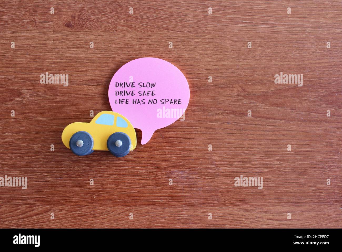 Drive safe quotes concept. Top view of toy car and quotes DRIVE SLOW ...