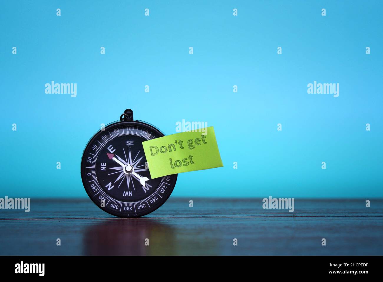 Close up image of compass and sticky note with text Don't get lost ...
