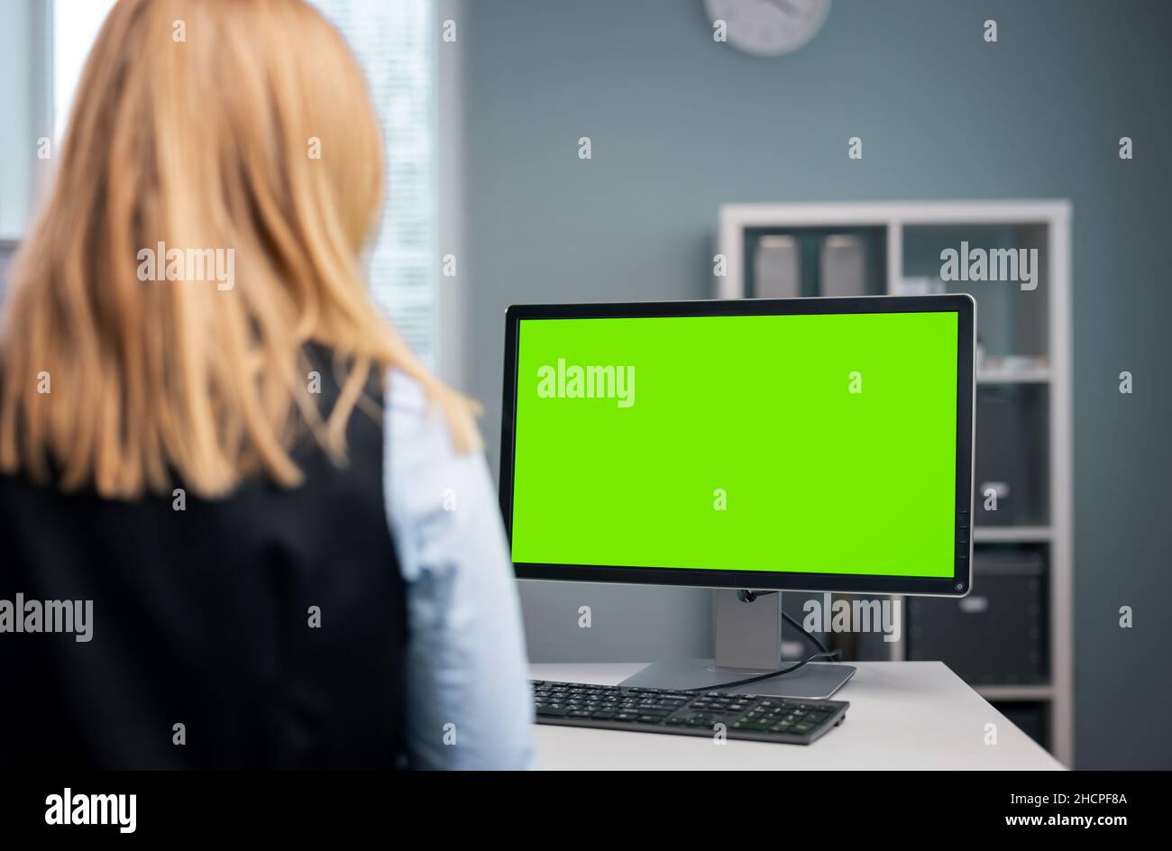 Woman using green screen computer Stock Photo - Alamy
