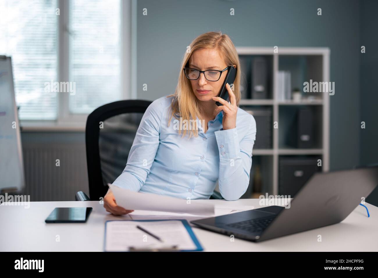 Mature woman talking smartphone laptop hi-res stock photography and images - Alamy