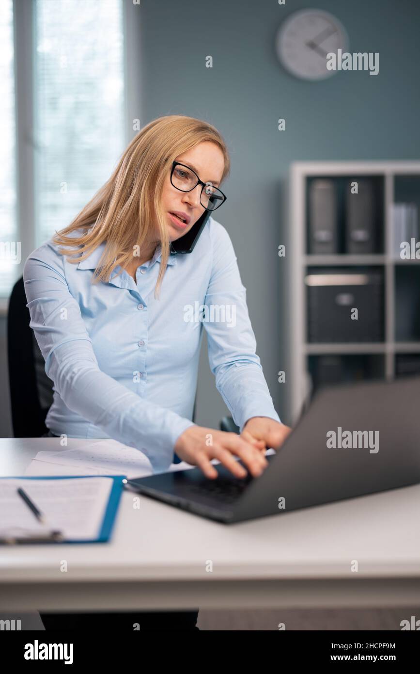 Busy woman working at office Stock Photo - Alamy