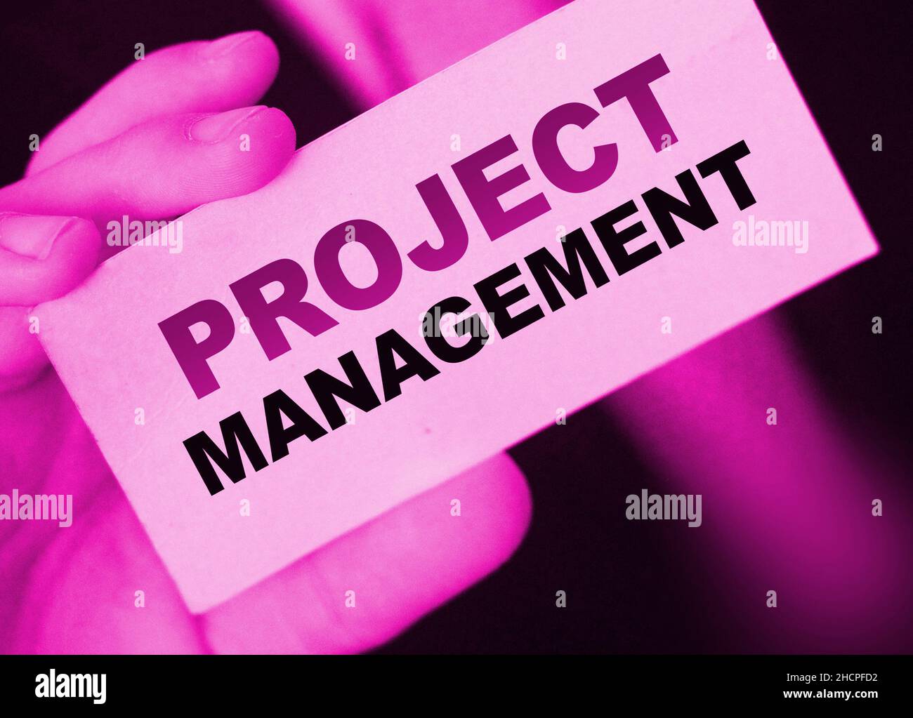 PROJECT MANAGEMENT words on card businessman holds. Business strategy ...