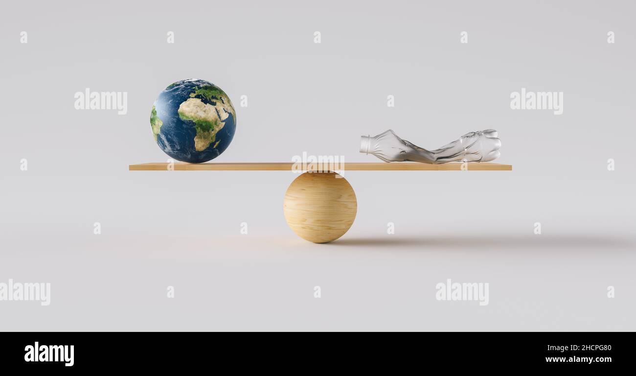 wooden scale balancing big Earth ball and crushed plastic bottle ...