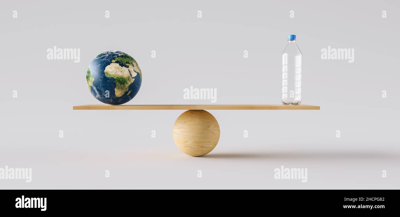 wooden scale balancing big Earth ball and plastic bottle. Concept of ...