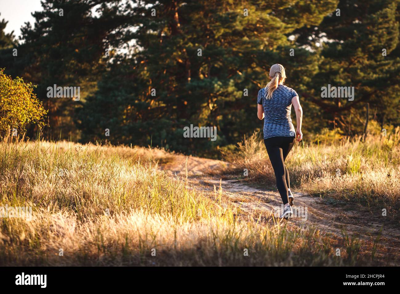 Woman run in nature. Female runner jogging outdoors. Sport training and ...