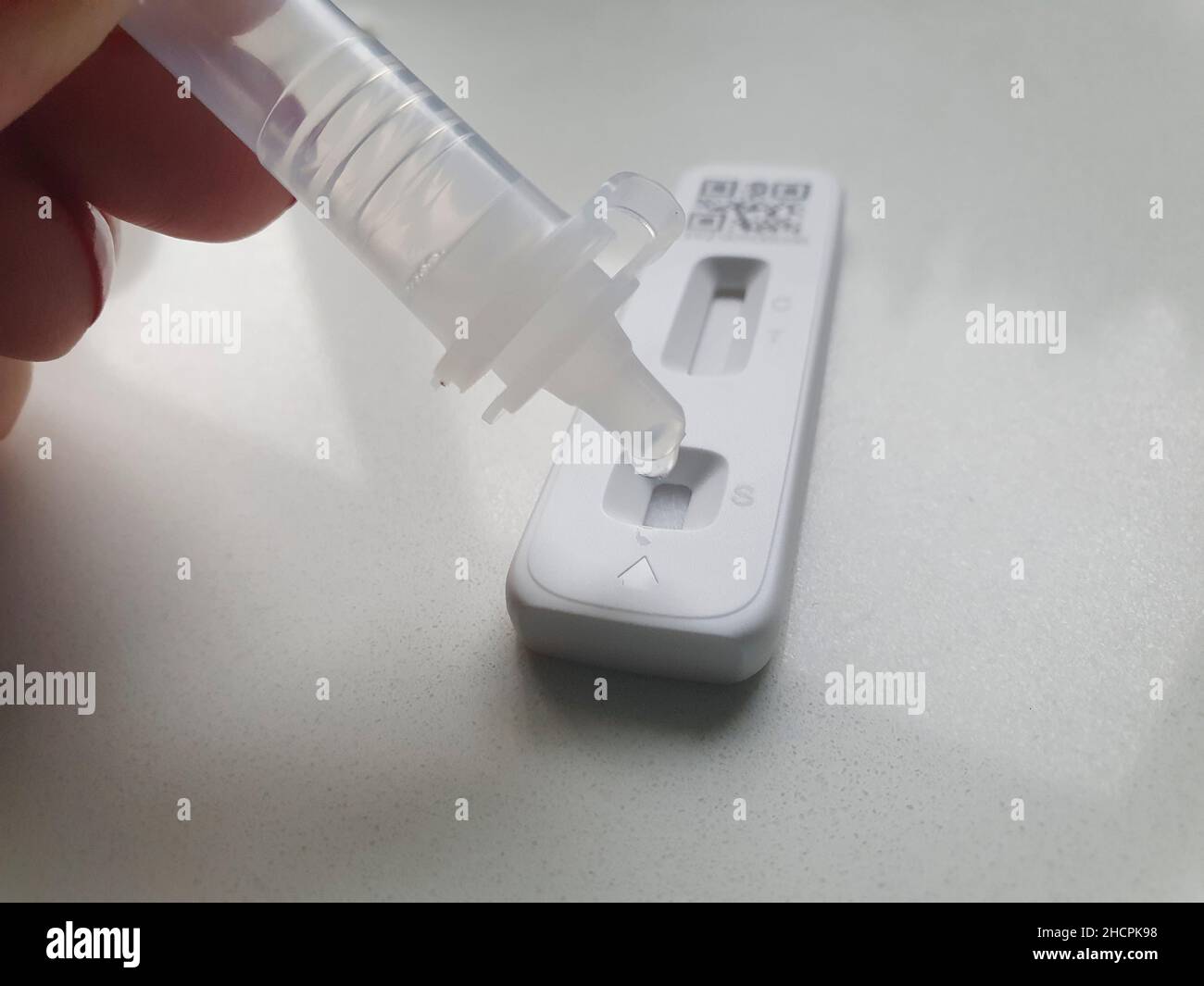 London, UK, 31 December 2021: a person drops buffer solution containing ...