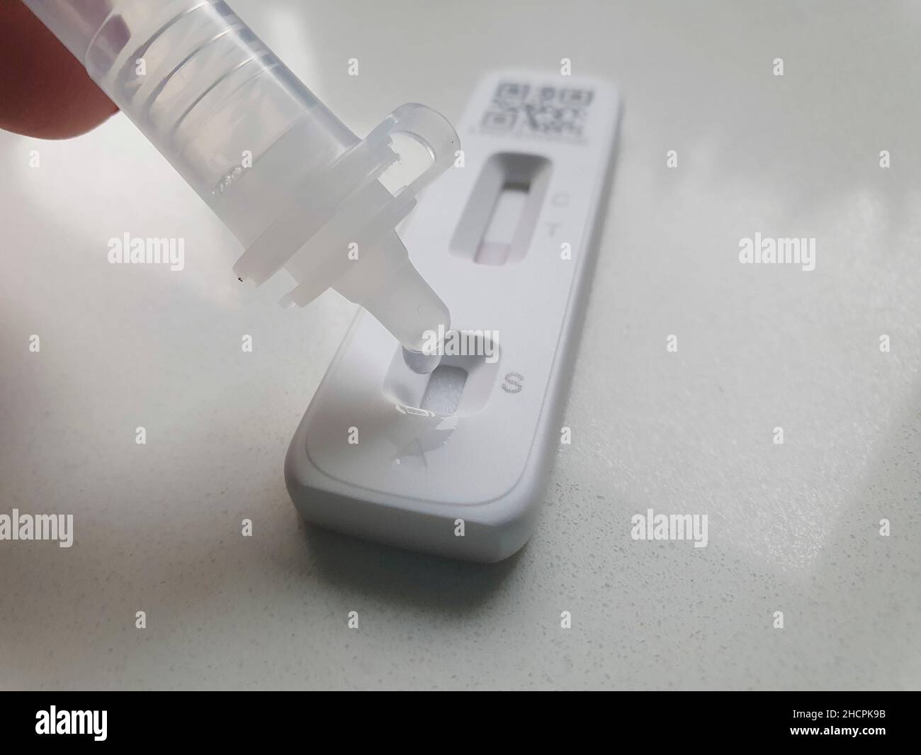 London, UK, 31 December 2021: a person drops buffer solution containing ...