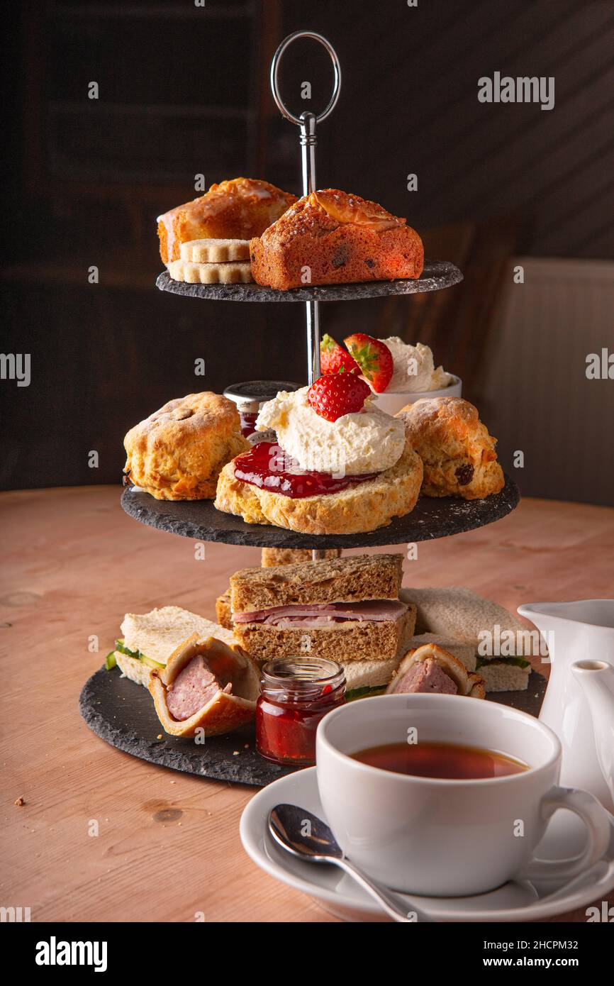 Afternoon tea with cakes and sandwiches Stock Photo - Alamy