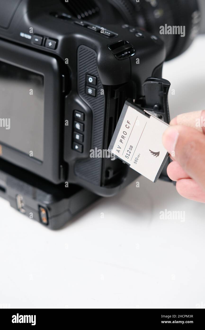 Vertical shot of a man putting a card into the camera Stock Photo - Alamy