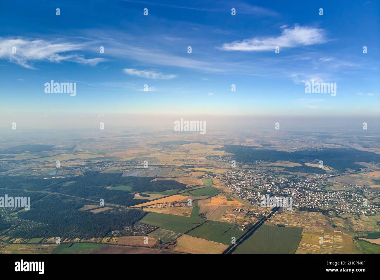 Aerial view from airplane window at high altitude of earth covered with ...