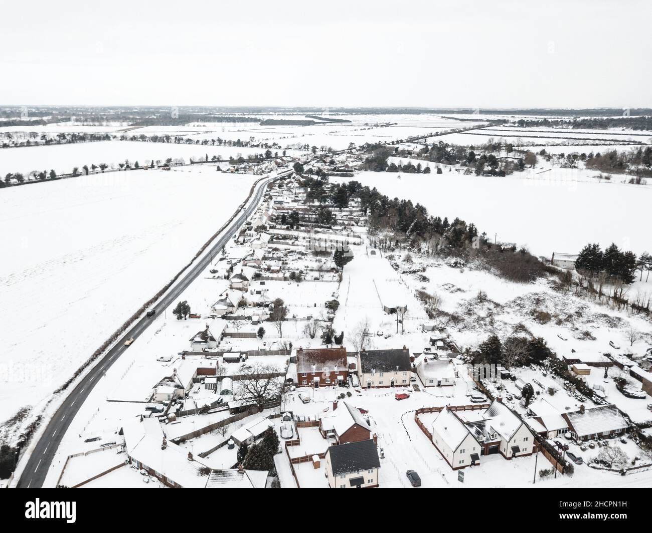 Aerial view of a small village in the British countryside during a rare ...