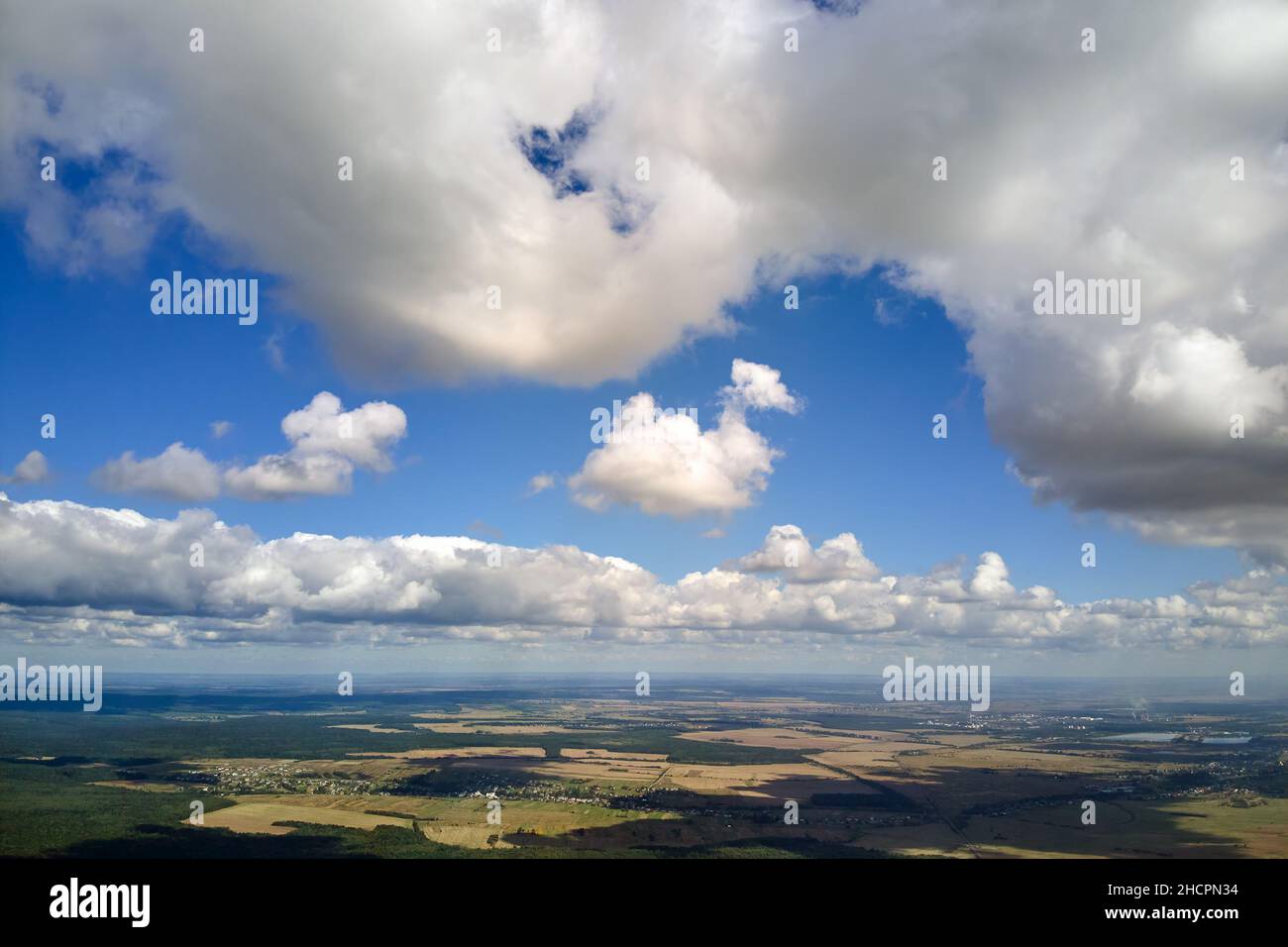 Aerial view from high altitude of earth covered with white puffy ...