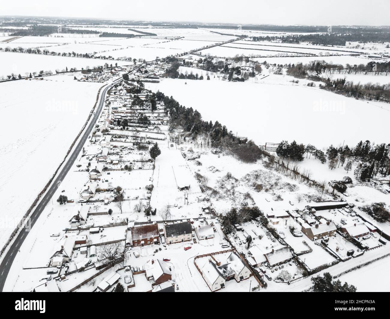 Aerial view of a small village in the British countryside during a rare ...