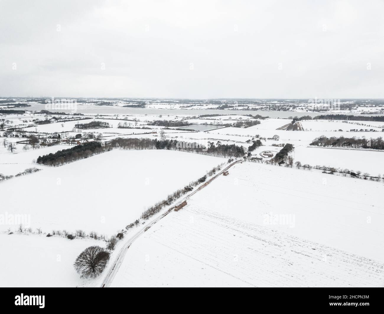 Aerial view of snow covered farm fields in the British countryside ...