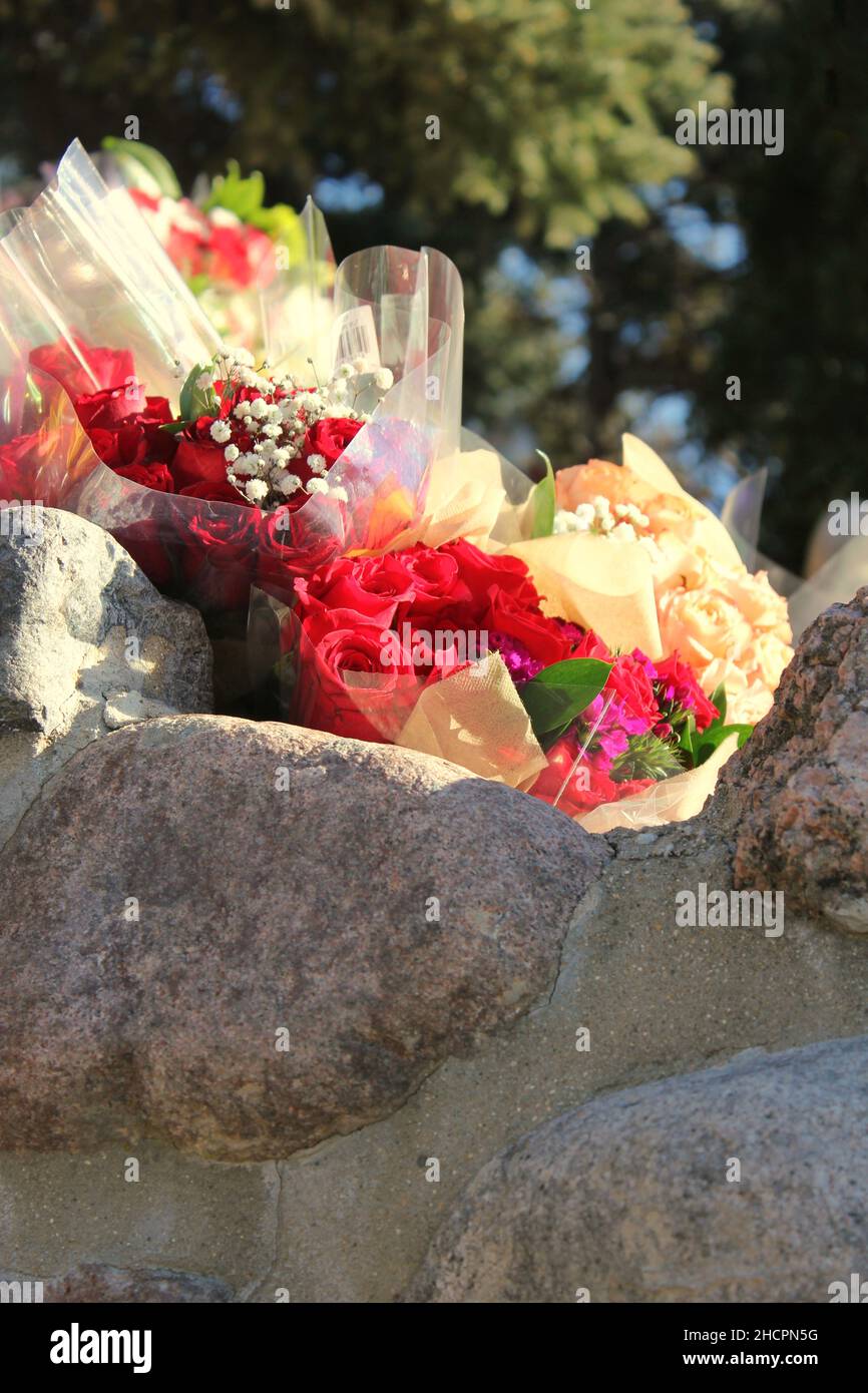 Many gorgeous bouquets of fresh flowers stacked high as an elegant ...